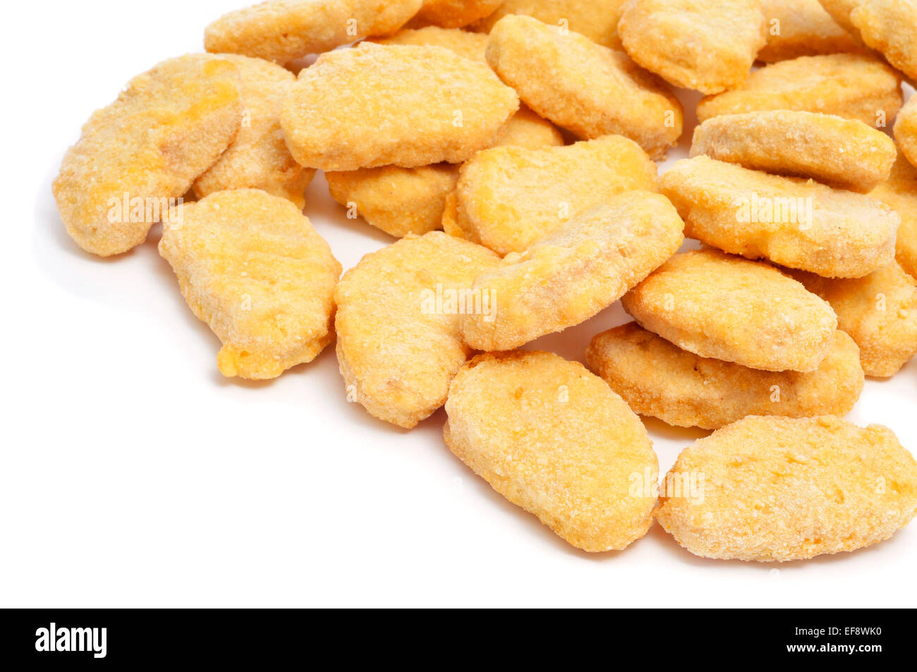 a pile of chicken nuggets on a white background Stock Photo - Alamy