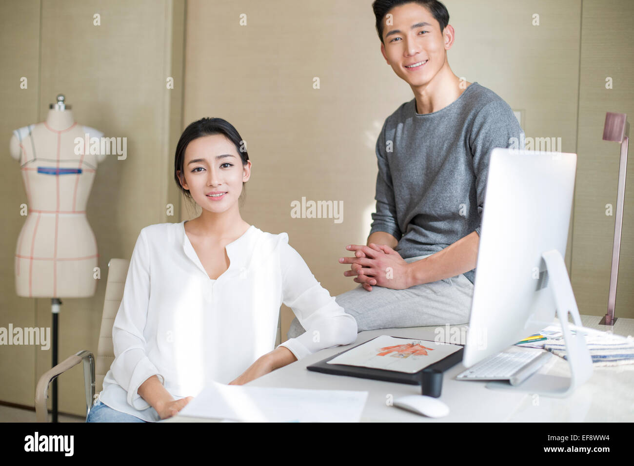 Young couple designing clothing together Stock Photo - Alamy