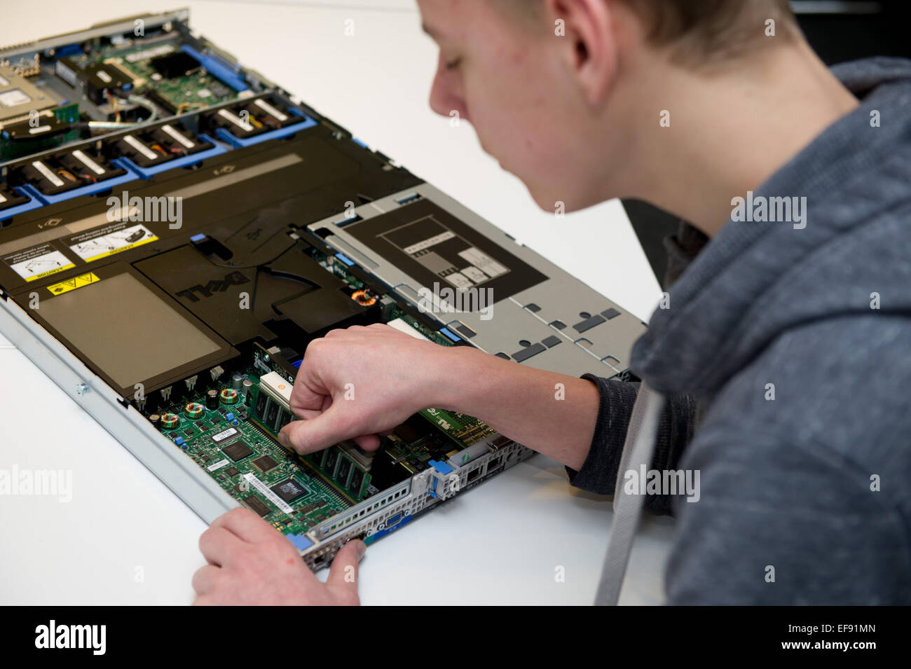 A boy working on the innards of a computer. Photo: Jan Haas Stock Photo ...