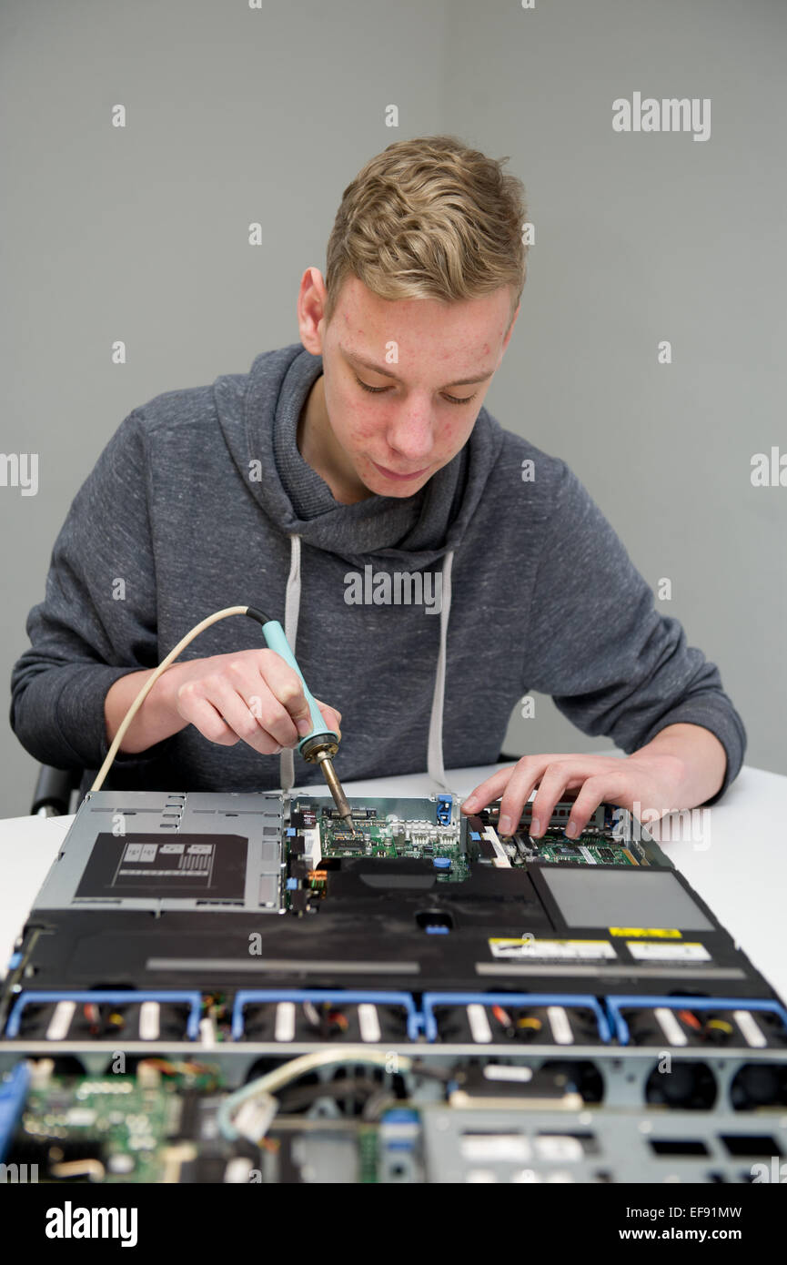 A boy working on the innards of a computer. Photo: Jan Haas Stock Photo ...