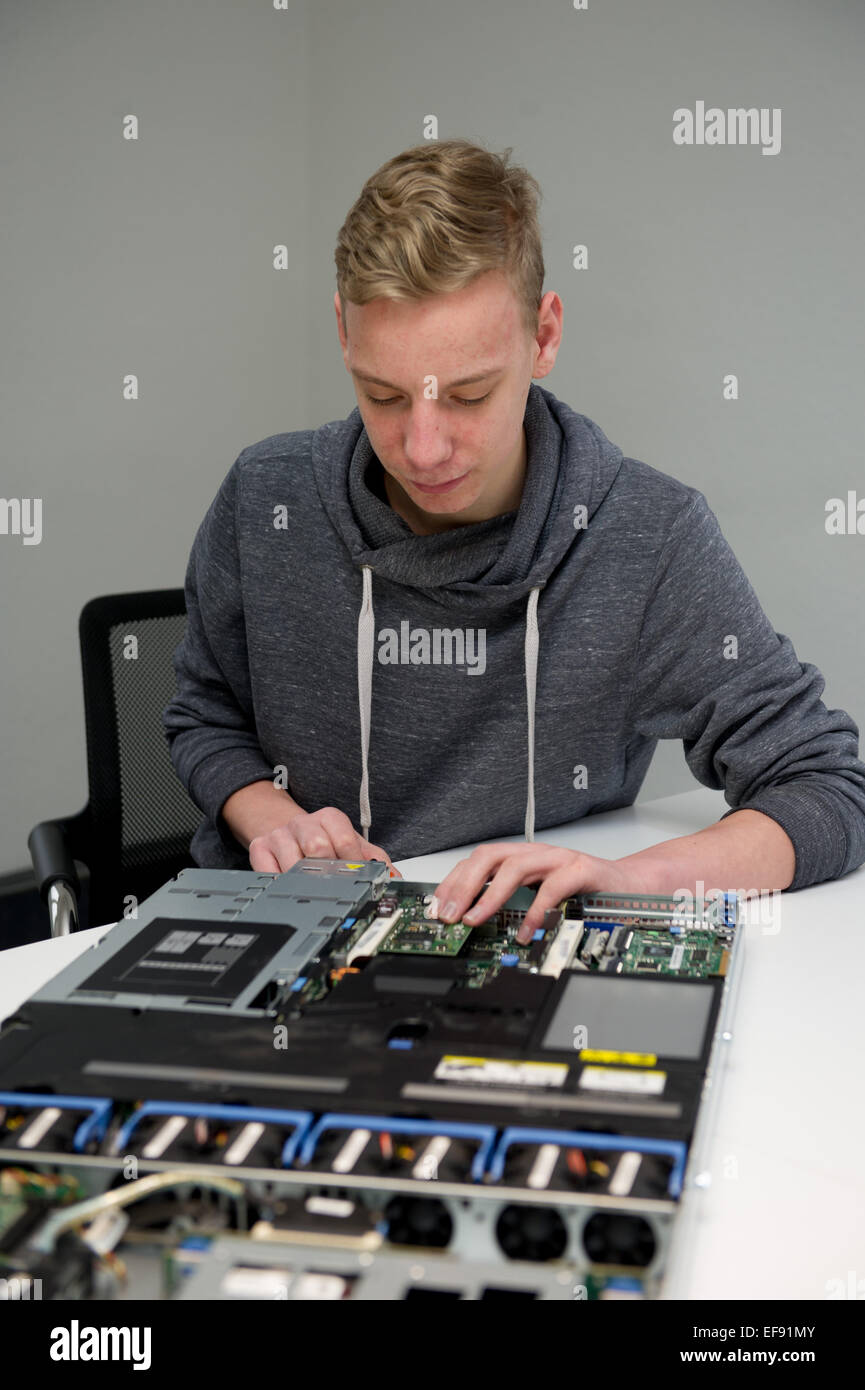 A boy working on the innards of a computer. Photo: Jan Haas Stock Photo ...