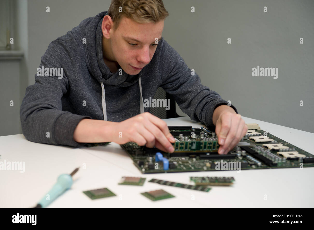 Boy repairing computer hi-res stock photography and images - Alamy