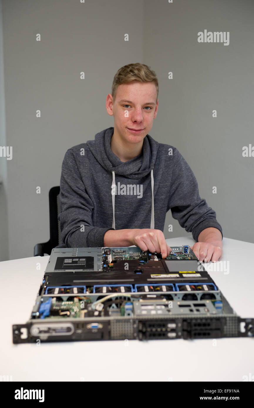A boy working on the innards of a computer. Photo: Jan Haas Stock Photo ...