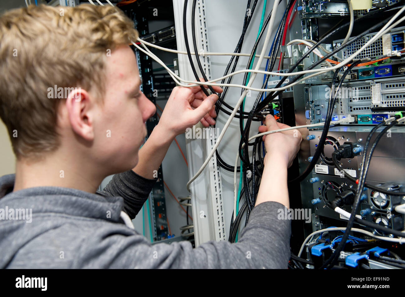 A boy working on the innards of a computer. Photo: Jan Haas Stock Photo ...