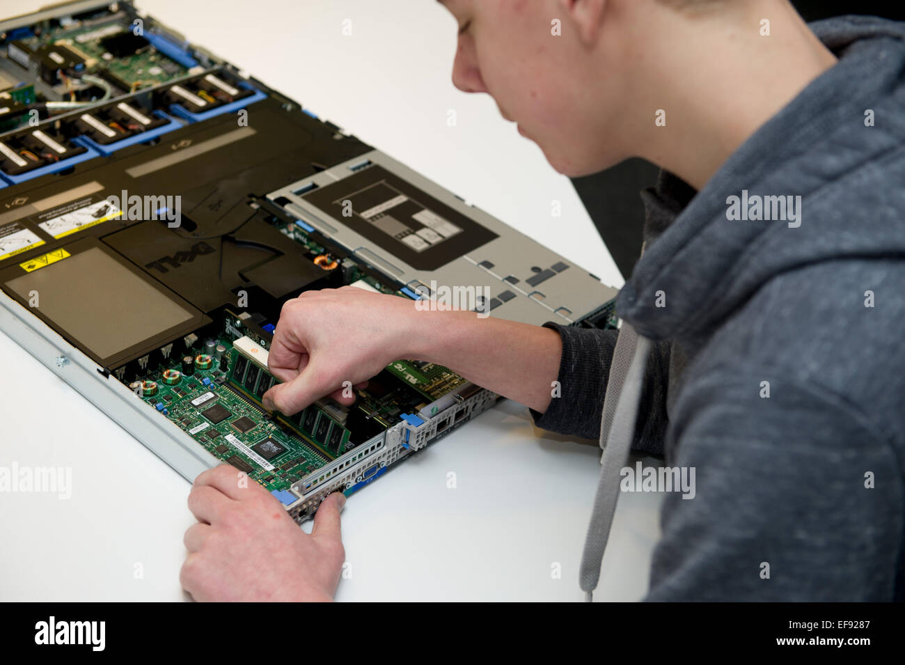 A boy working on the innards of a computer. Photo: Jan Haas Stock Photo ...