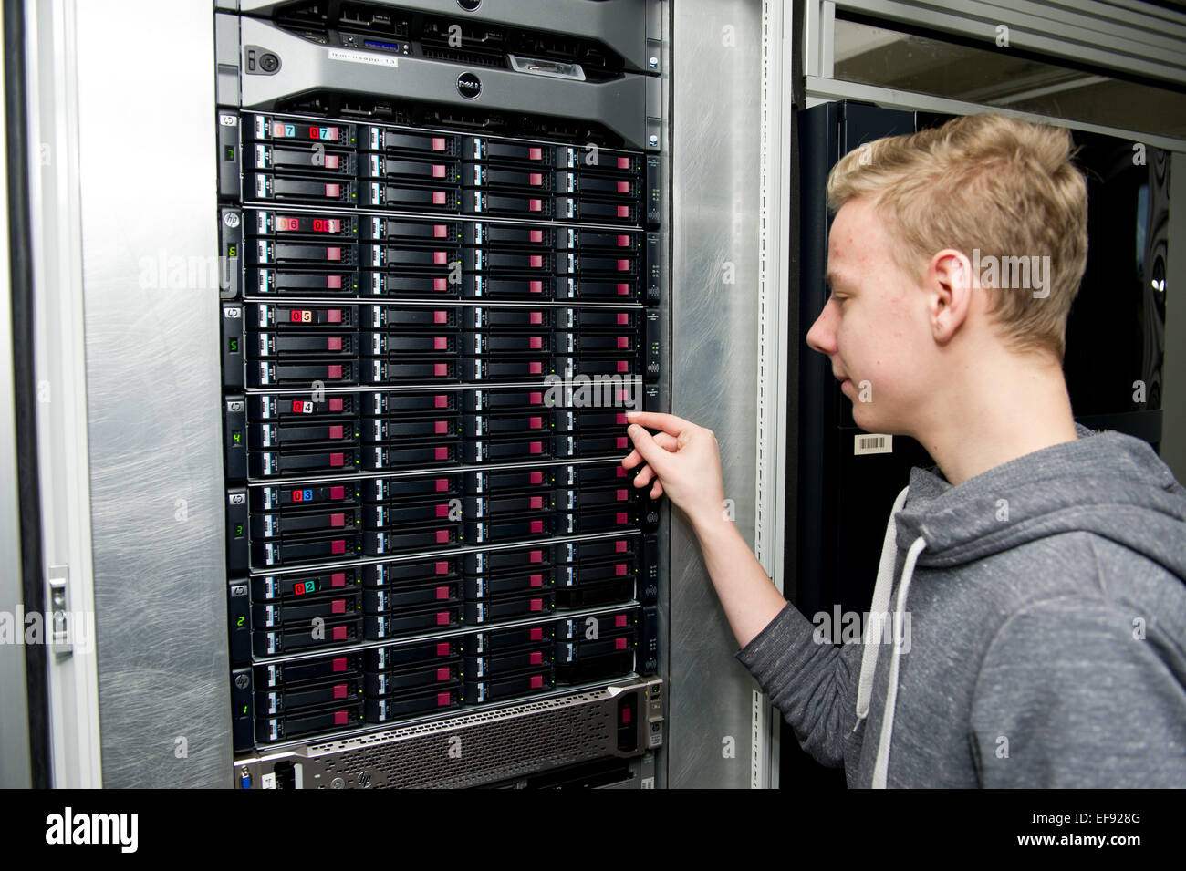 A boy working on the innards of a computer. Photo: Jan Haas Stock Photo ...