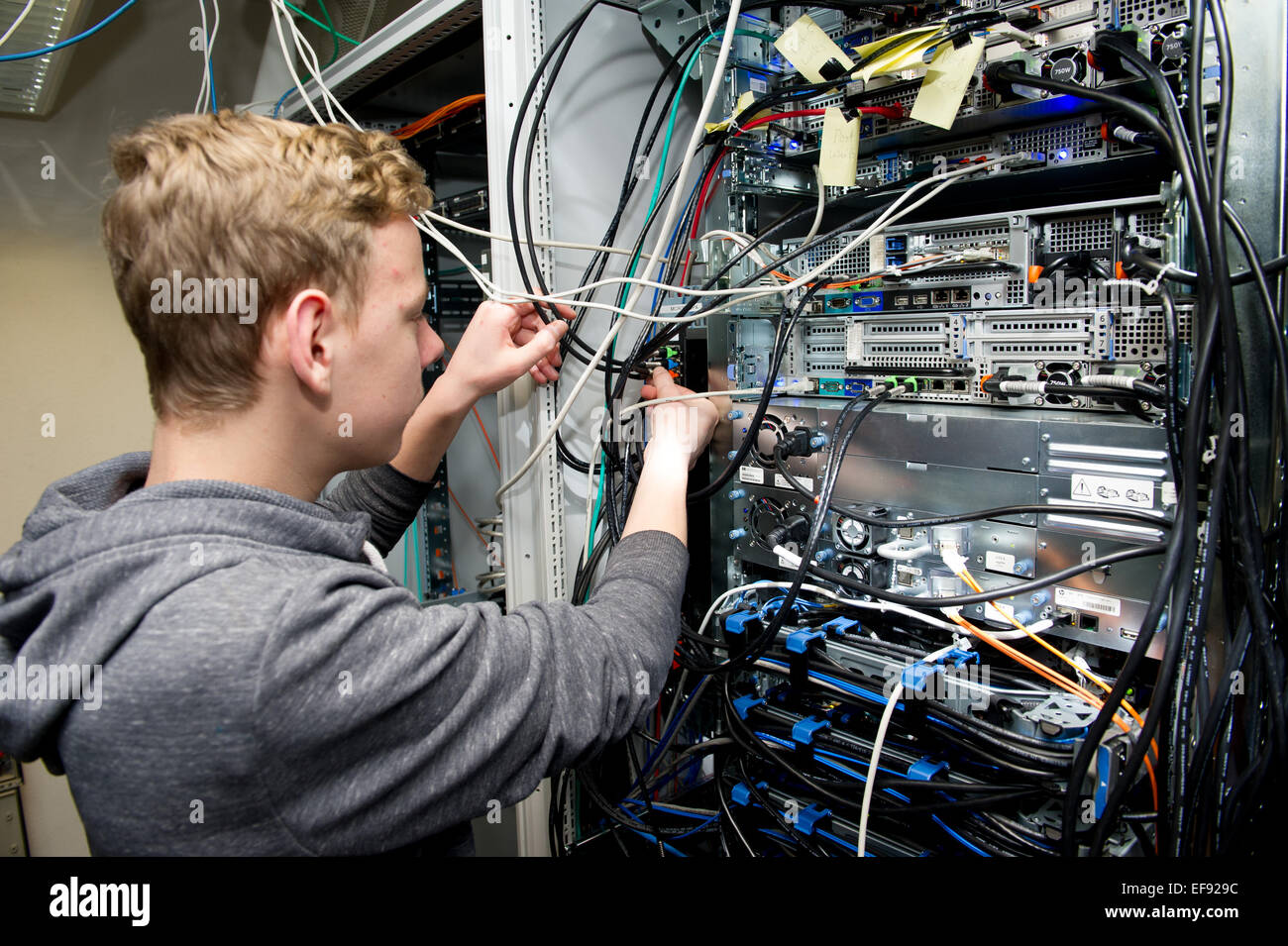 A boy working on the innards of a computer. Photo: Jan Haas Stock Photo ...