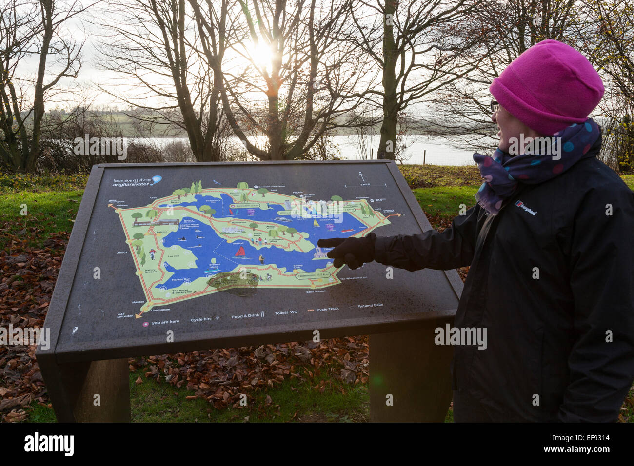 Woman in a pink hat points to a tourist map of Rutland Water with the ...