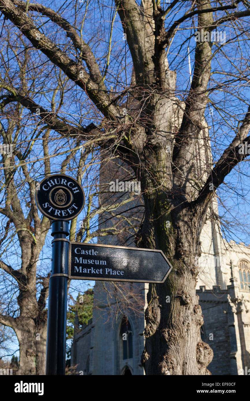 Metal signpost pointing to the castle, museum and market place in ...