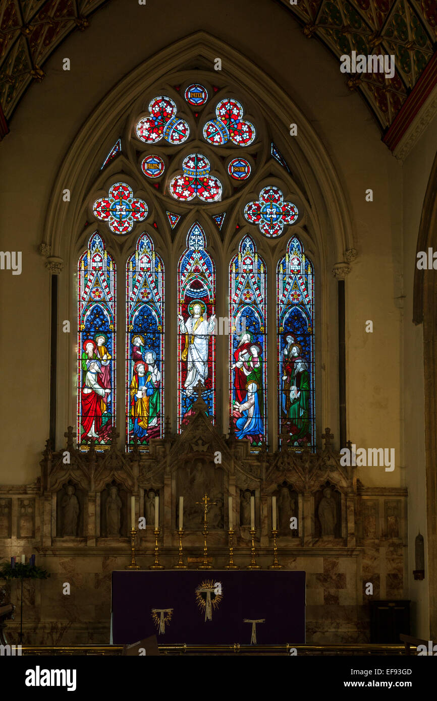 The alter with decorated style stained glass window behind, in the ...