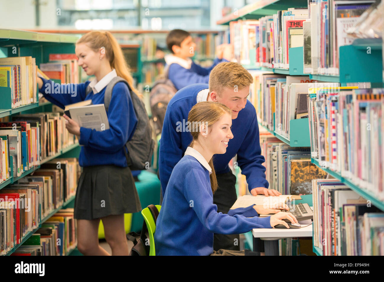 Teenage students using computer in college library Stock Photo - Alamy