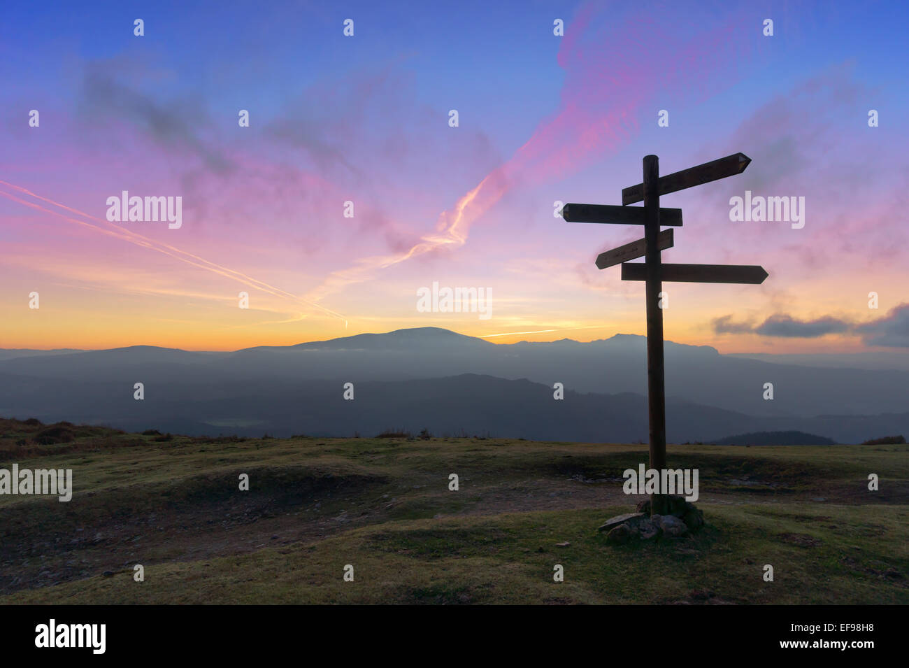 wooden signpost on mountain at sunset Stock Photo - Alamy