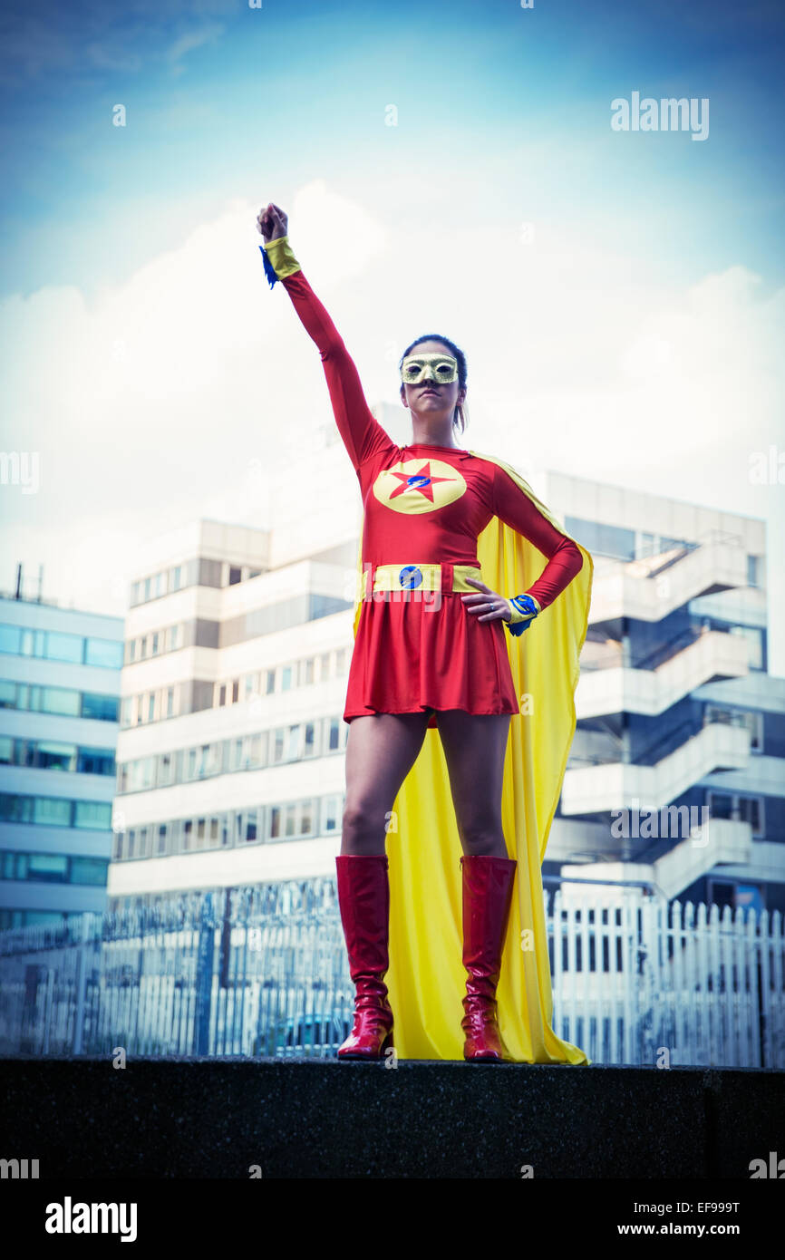 Superhero standing proudly in city Stock Photo - Alamy