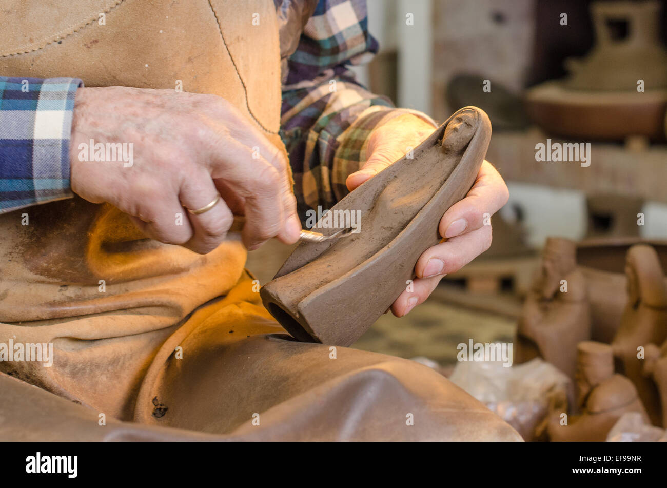 Old hands of a potter shaping a clay figure Stock Photo - Alamy