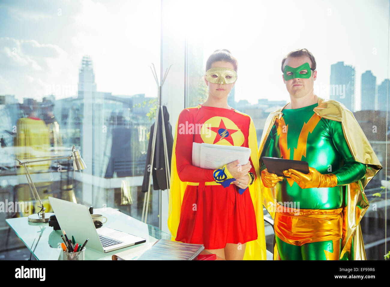 Superheroes standing in office Stock Photo - Alamy