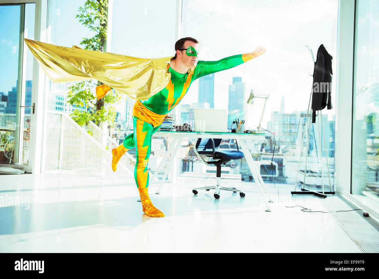 Superhero flying in office Stock Photo - Alamy