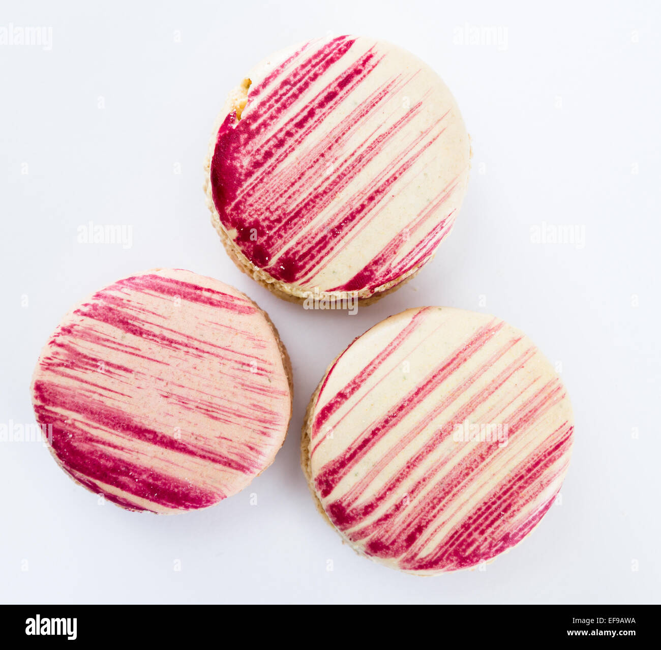 serving of three french macaroons on a white background Stock Photo - Alamy