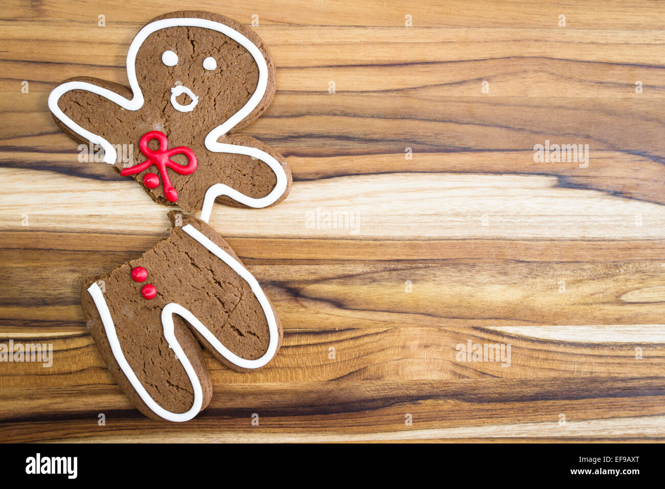 holiday cookie, a gingerbread man broken in half with a scared ...