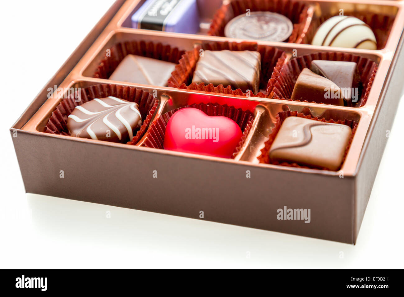 Assorted chocolates in brown box, with red heart chocolate Stock Photo ...