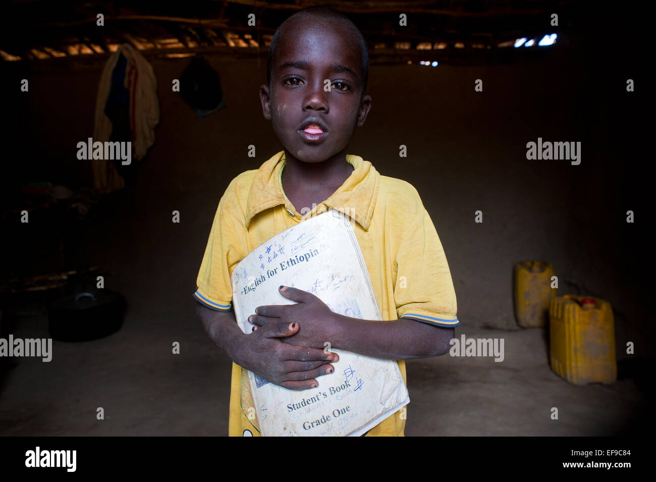 Schoolboy holding a english book. He belongs to the Kereyu tribe ...