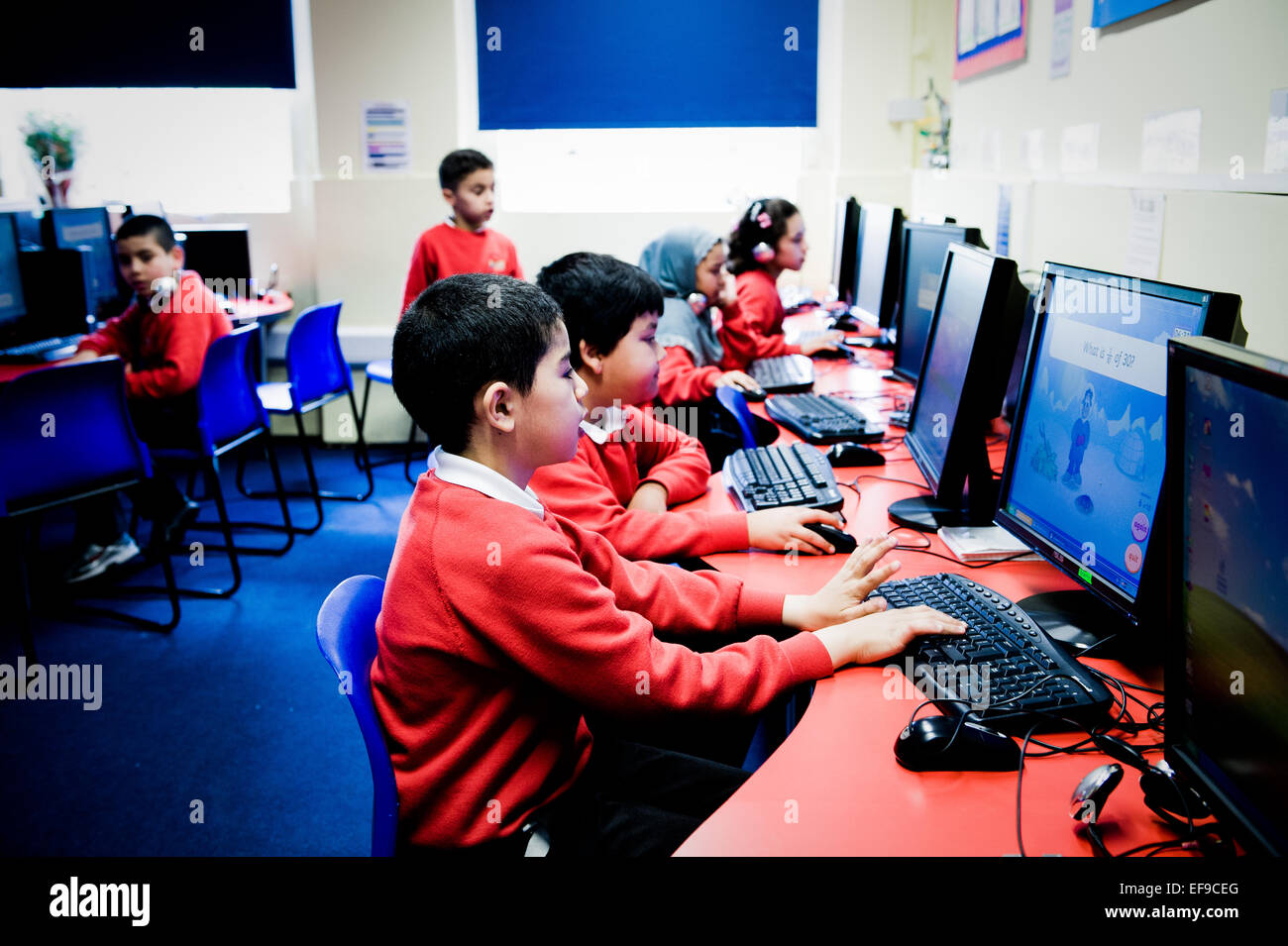 Inner city primary school children using computer suite at primary ...