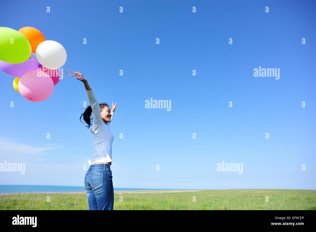 one young asian woman with colorful balloons Stock Photo - Alamy