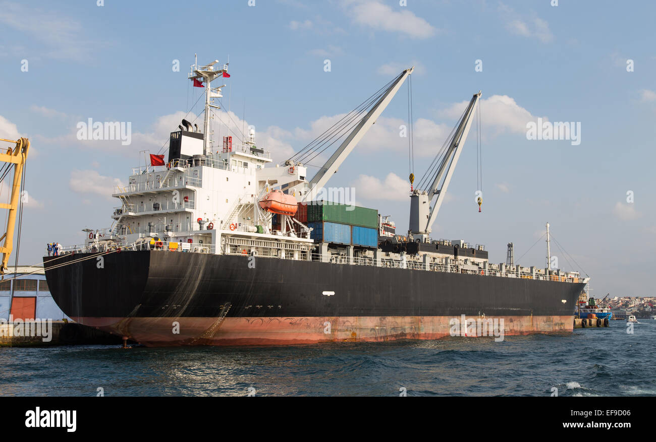 Cargo ship loading in a trading port Stock Photo - Alamy
