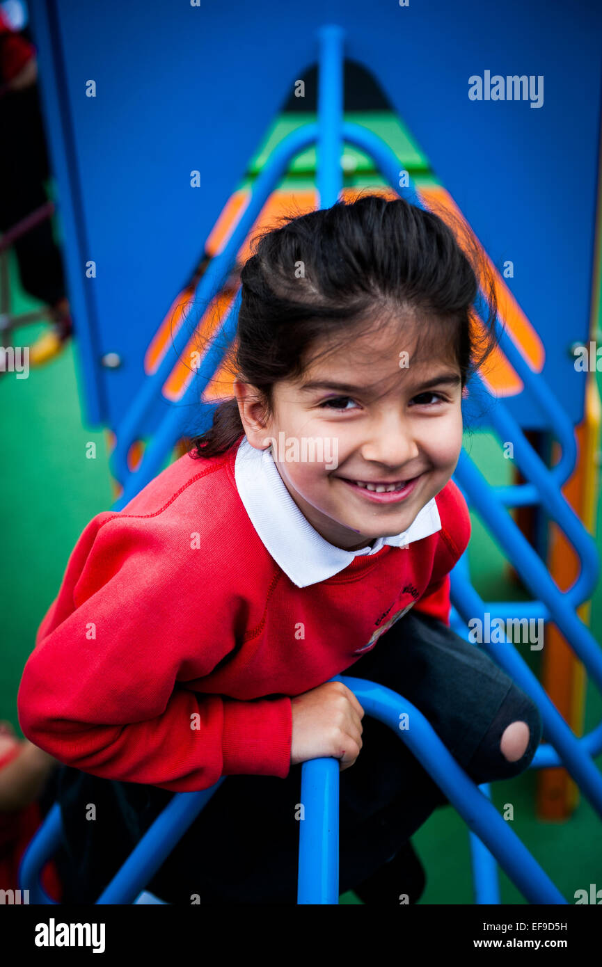 Happy smiling school girl playing in the playground of Primary school ...