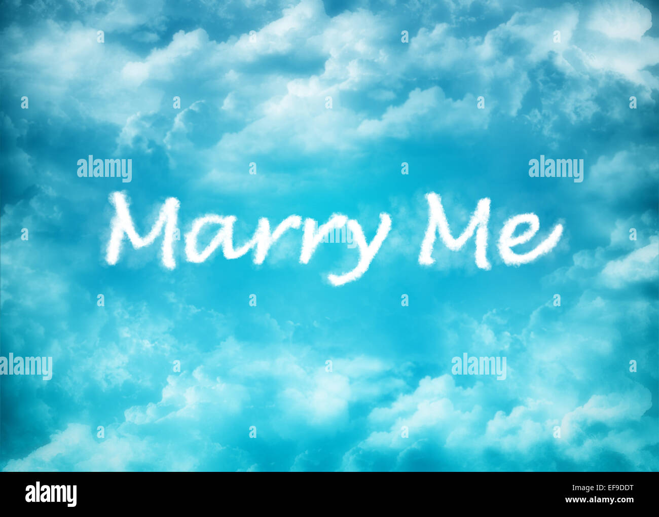 Inscription Marry Me on blury cloudy background Stock Photo - Alamy