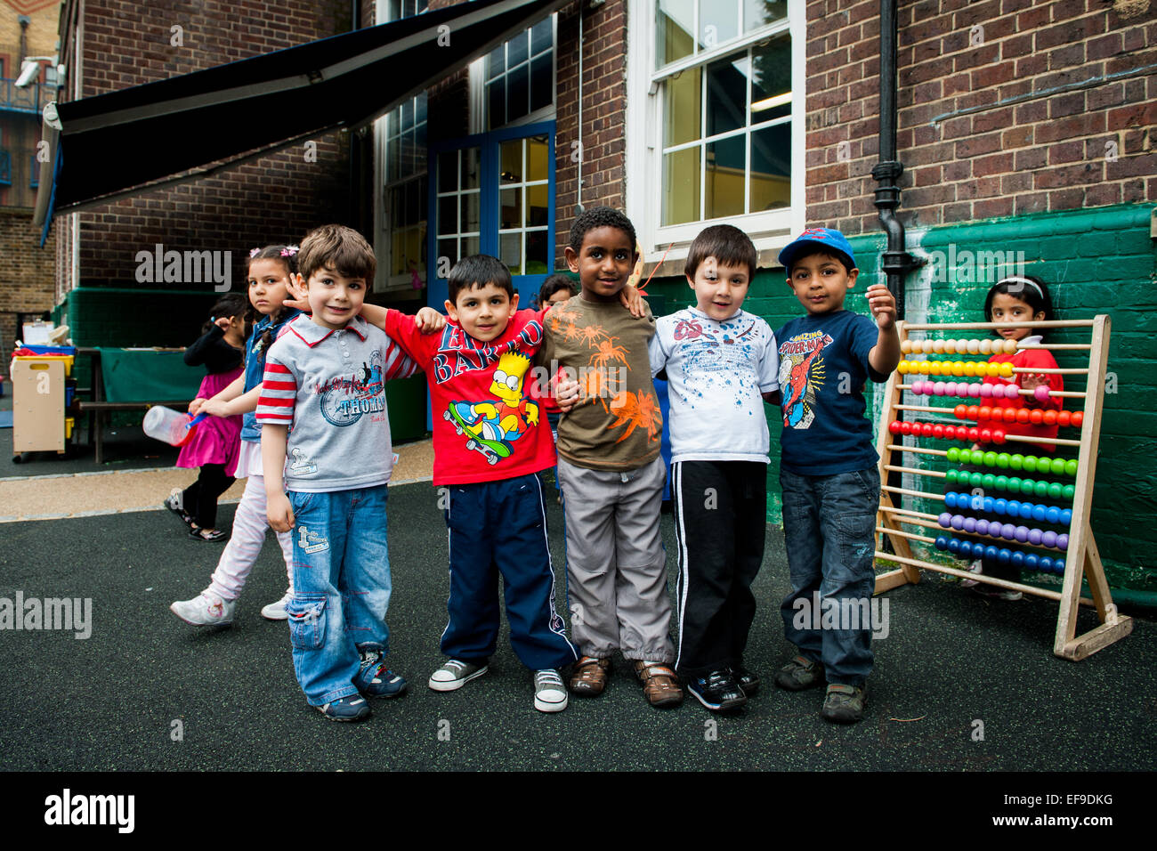 Happy smiling children playing in the playground of Primary school in ...