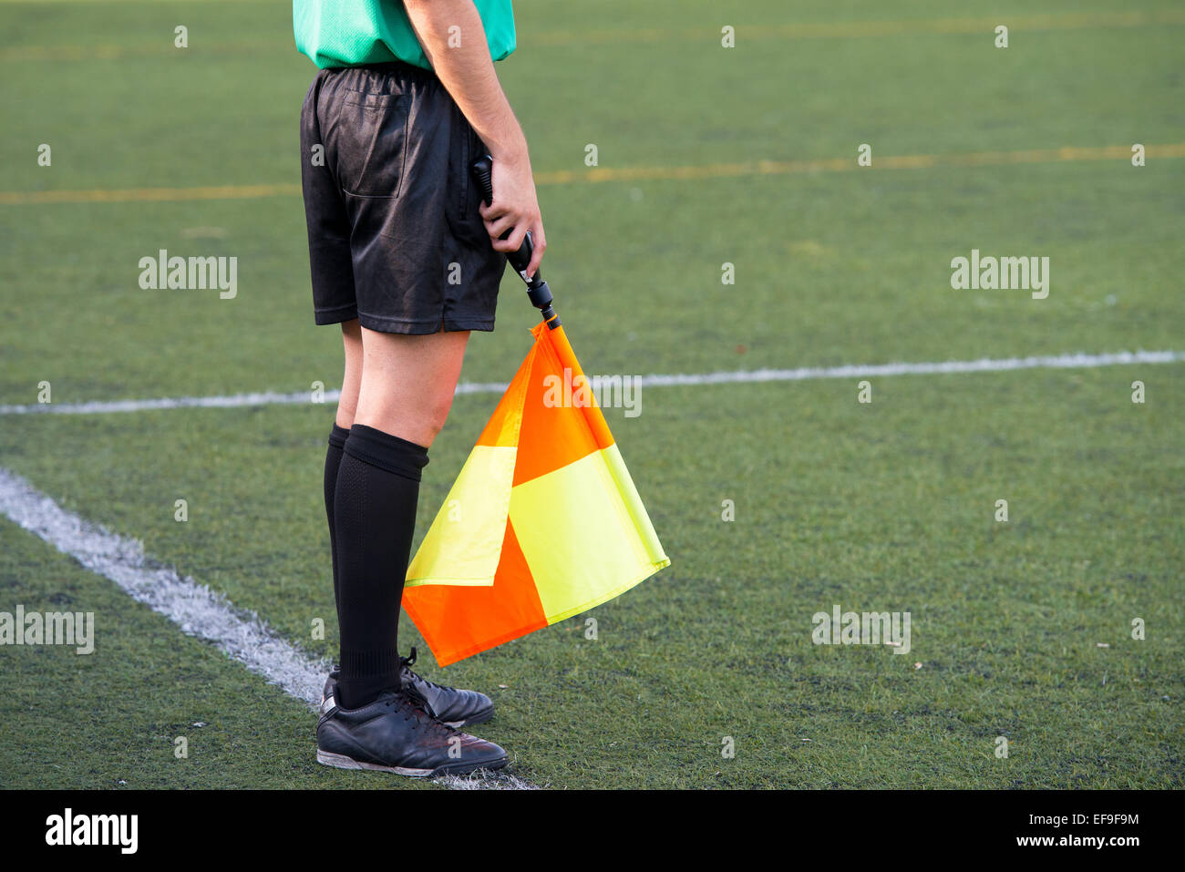 Soccer football referee linesman with a flag Stock Photo - Alamy