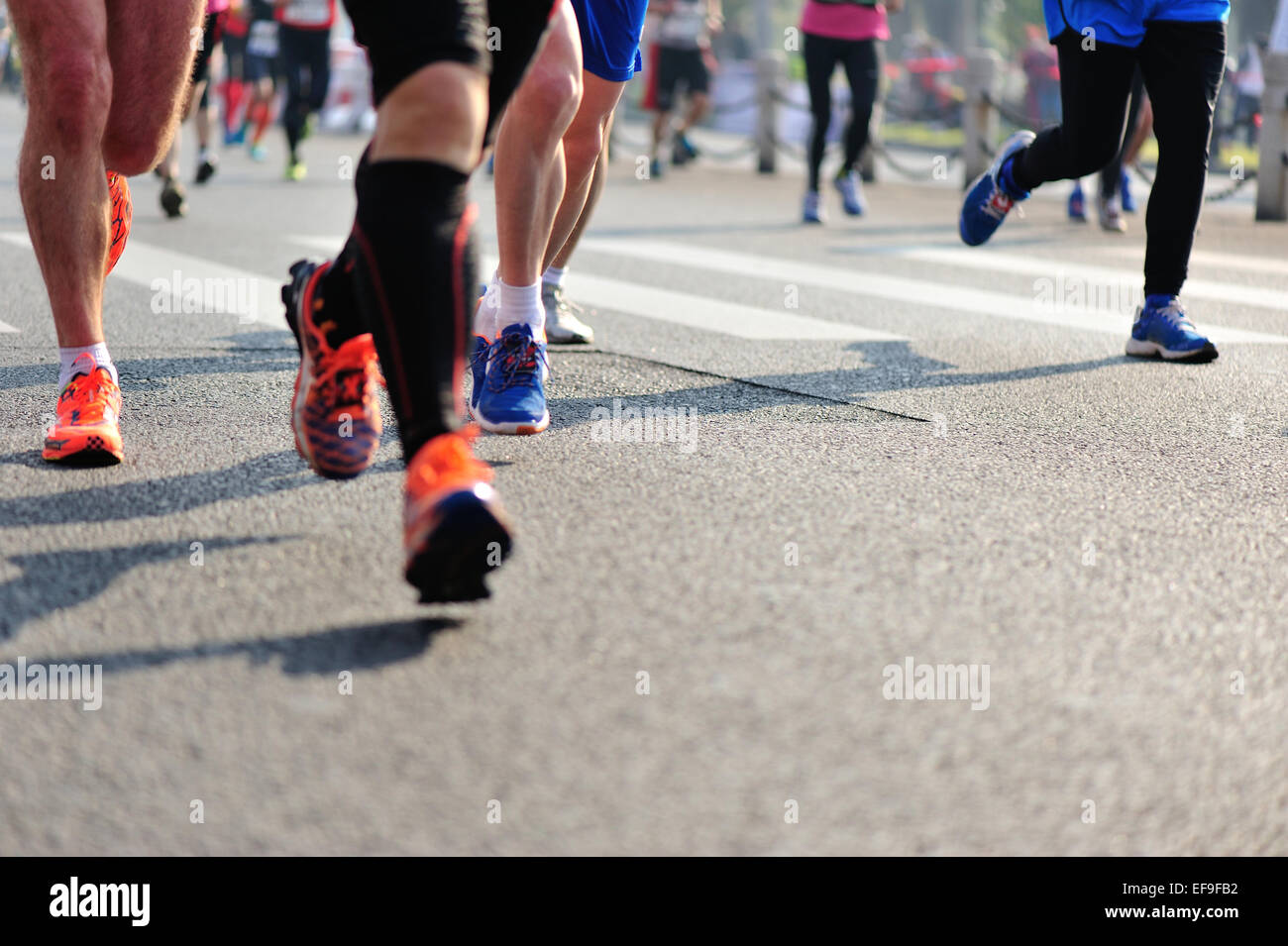 marathon runners runnning on city road Stock Photo - Alamy