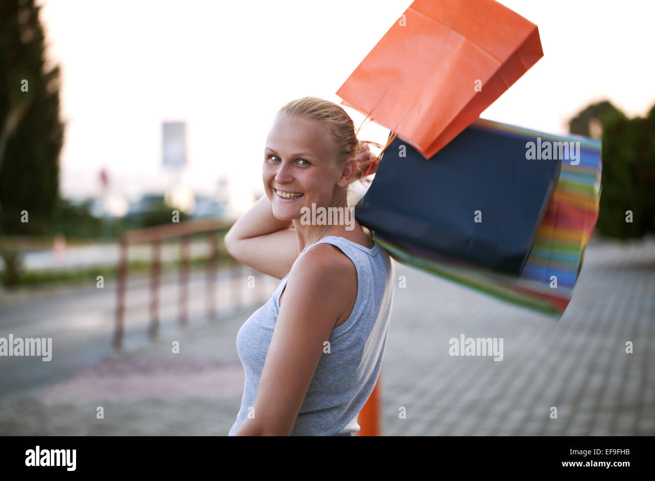 Young woman outdoor excited at good shopping Stock Photo - Alamy
