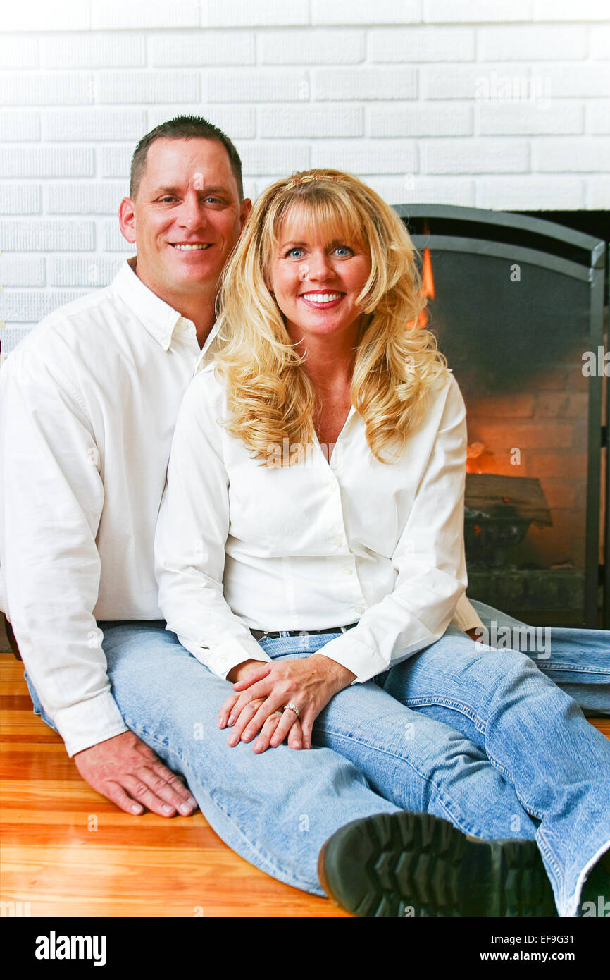 Portrait of a beautiful married couple at home in front of their ...