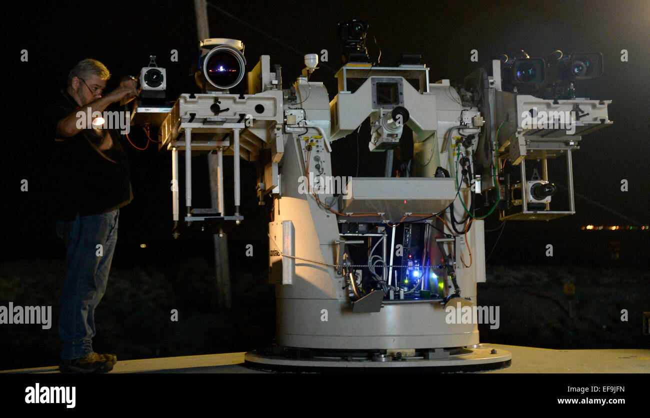 Vandenberg AFB, California- Tracking camera crews do last minute checks as the tower rolls back ...