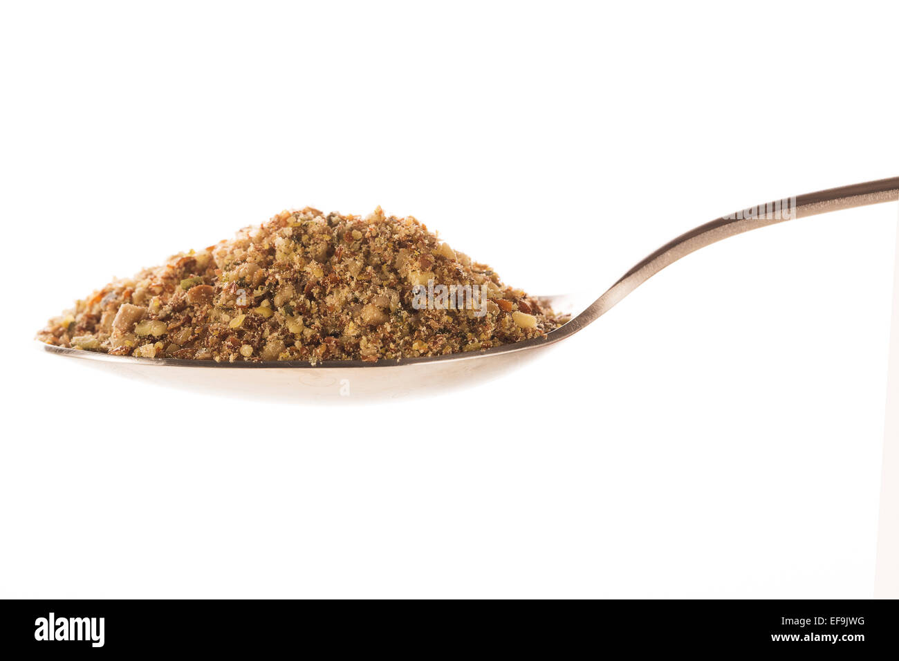 Spoonful of healthy mixed ground nut topping for desserts or salads ...