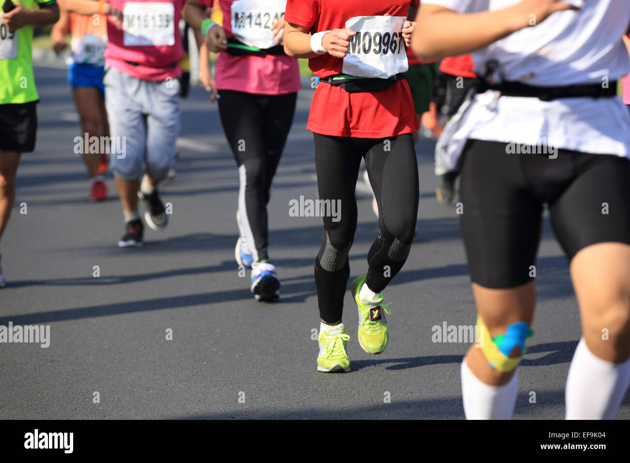 marathon runners runnning on city road Stock Photo - Alamy