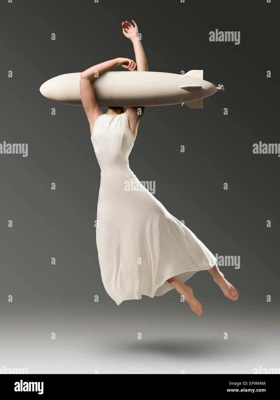 Fantasy image of woman whose head is a blimp floating above floor Stock ...