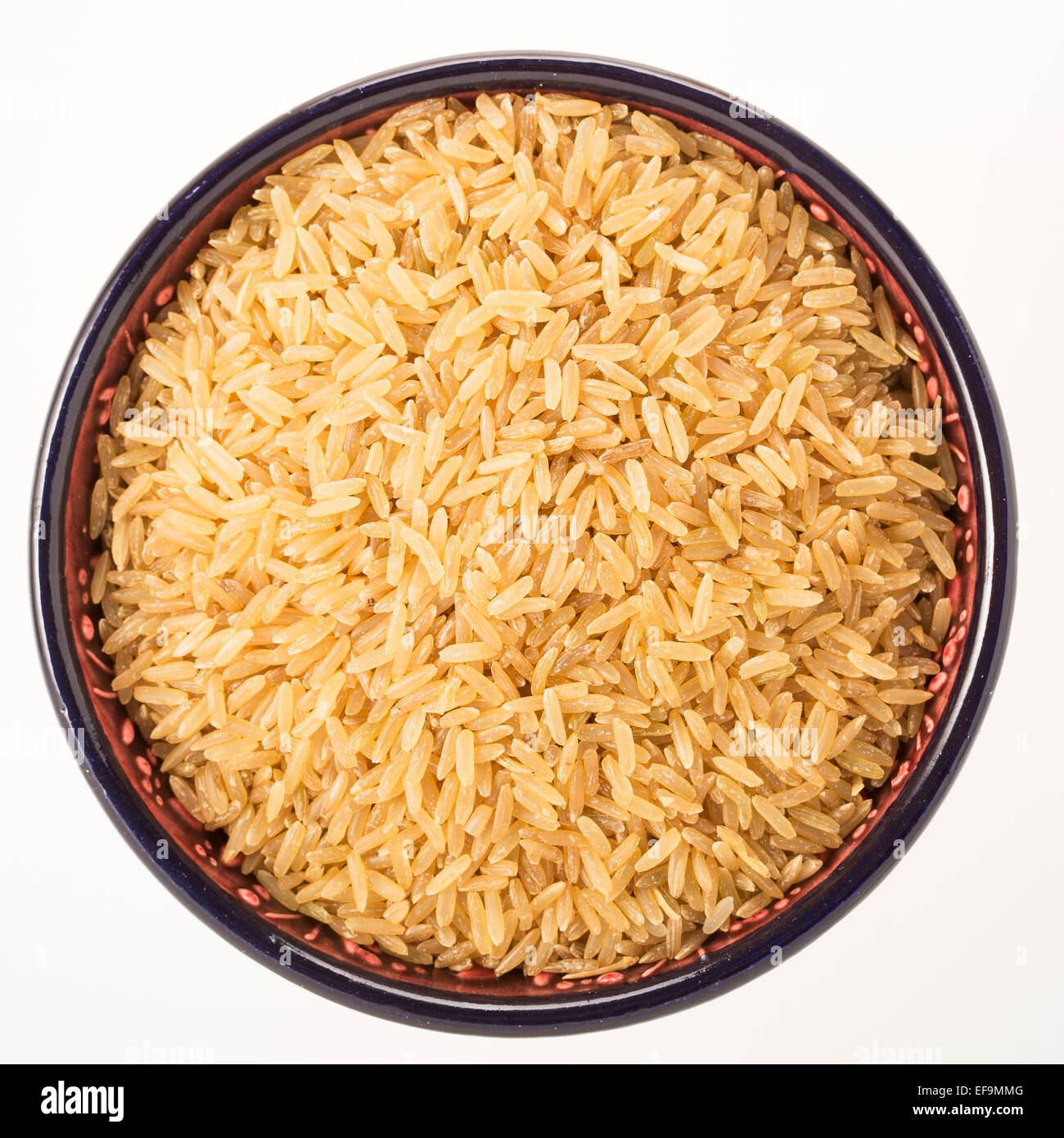 Brown rice in bowl isolated on white background Stock Photo - Alamy