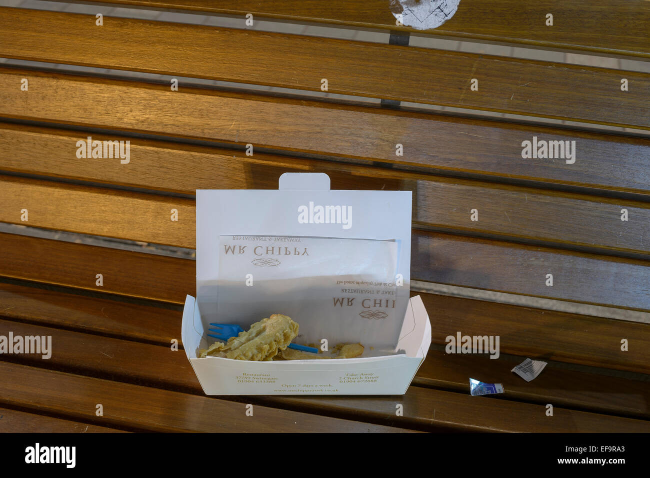 Discarded fish and chips on a city centre bench at night. York, UK ...