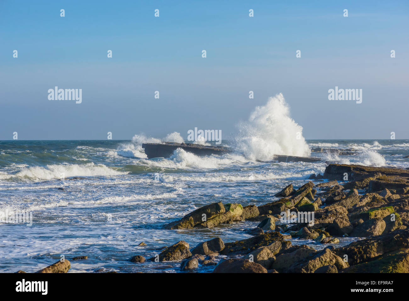 Waves crash against a jetty in heavy seas at Filey Brigg. Nobody Stock ...