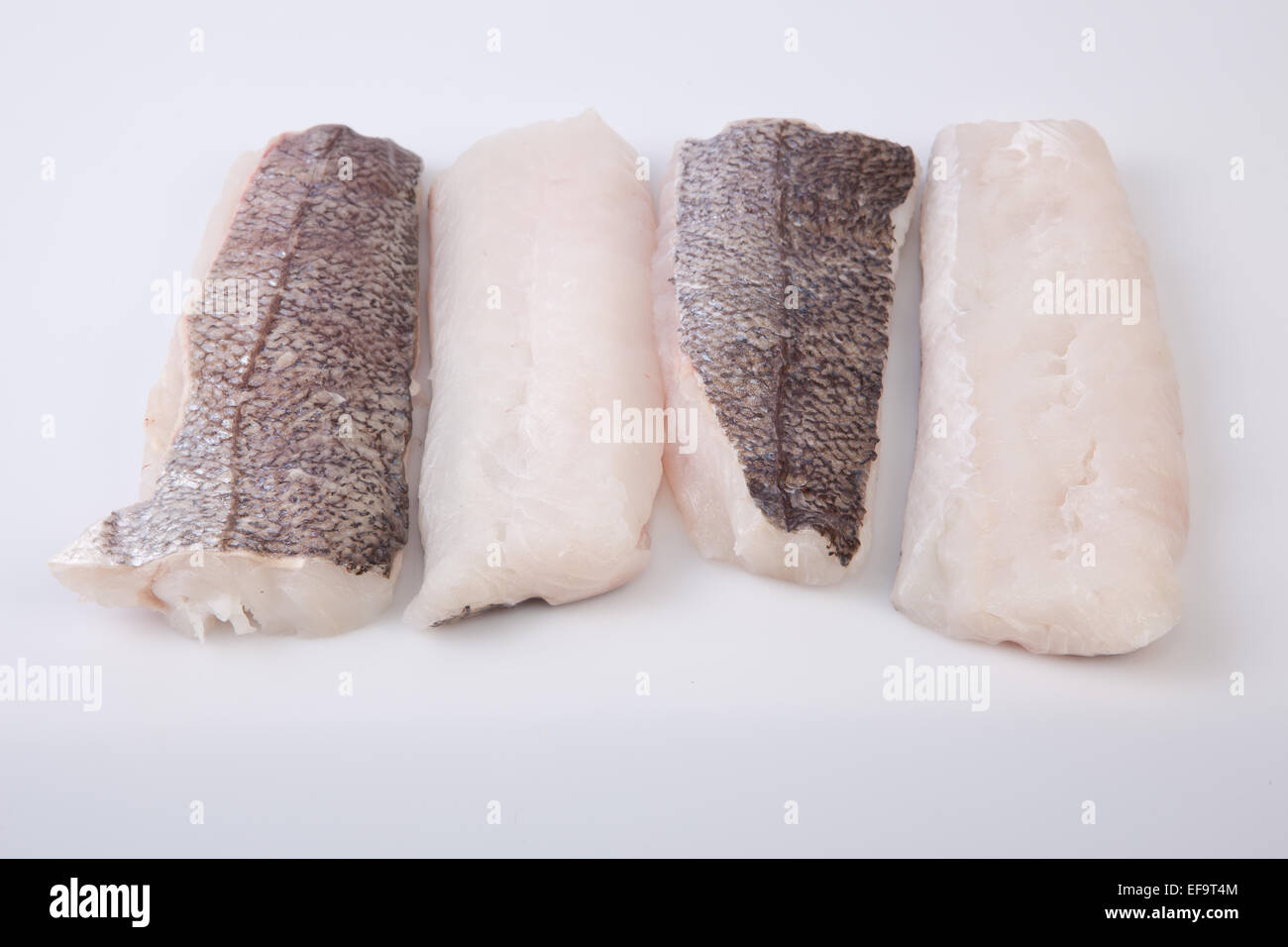 Boneless hake steaks. Isolated over white background Stock Photo - Alamy