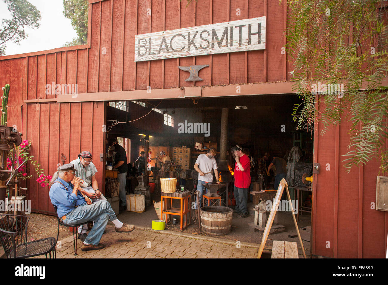 Using ancient techniques, modern day amateur blacksmiths work in an ...