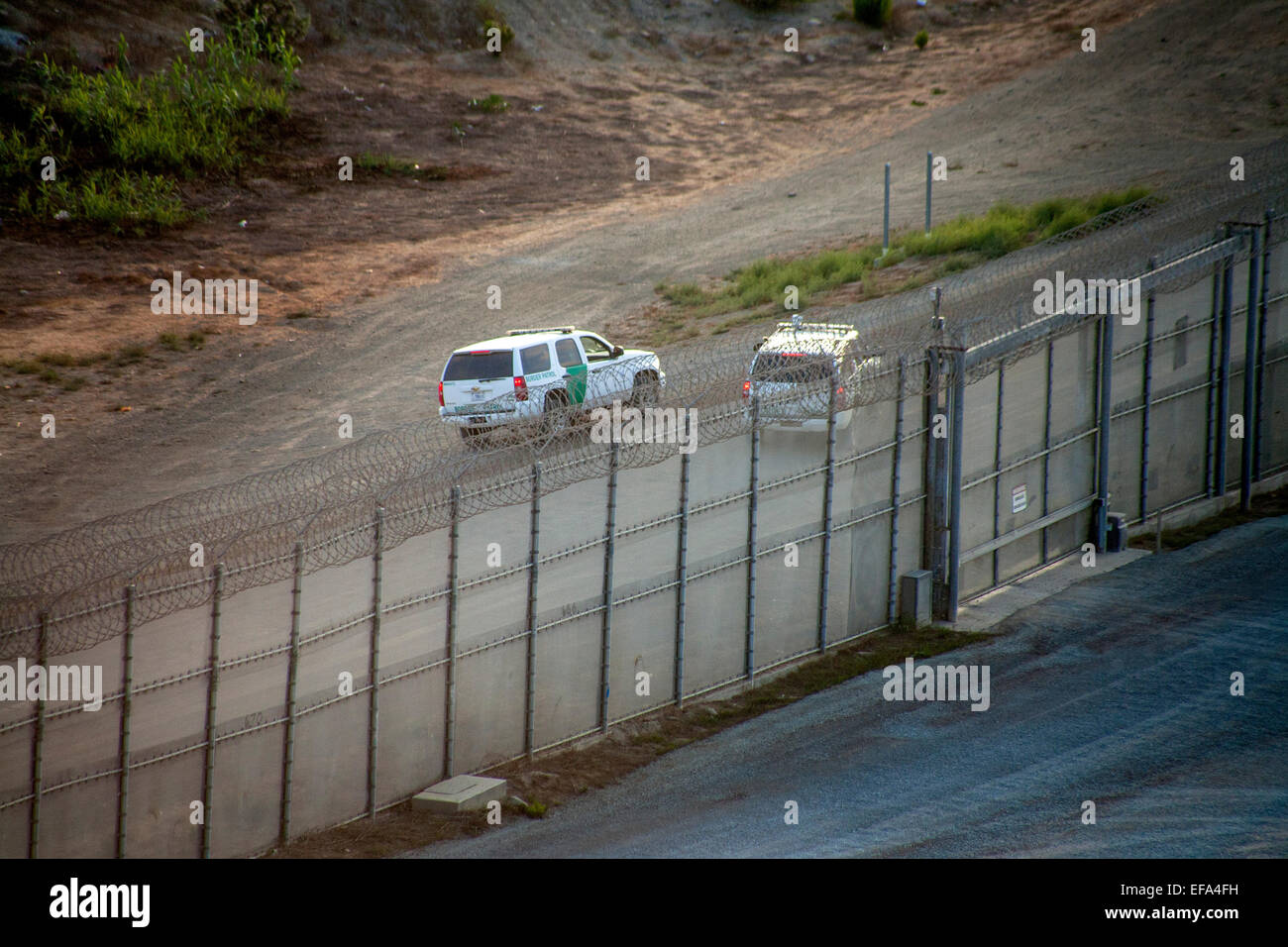 Two Border Patrol SUVs police the U.S./Mexico Border near Tijuana. The ...