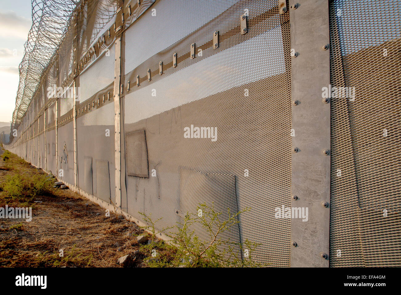 Patched holes in the international fence on the U.S./Mexico border ...