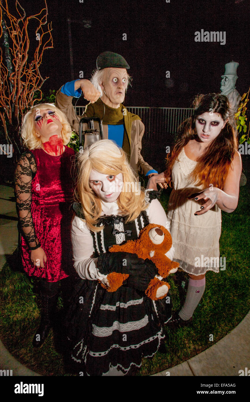 Three costumed lady ghouls pose with a ghostly figure getting into the ...