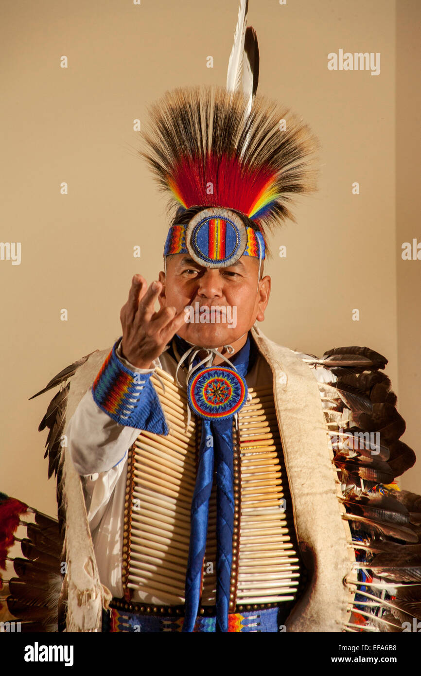 A Navajo Indian dancer wearing tribal costume explains traditional ...