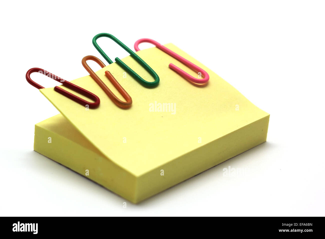 Paper clip and notepad isolated on white background Stock Photo - Alamy