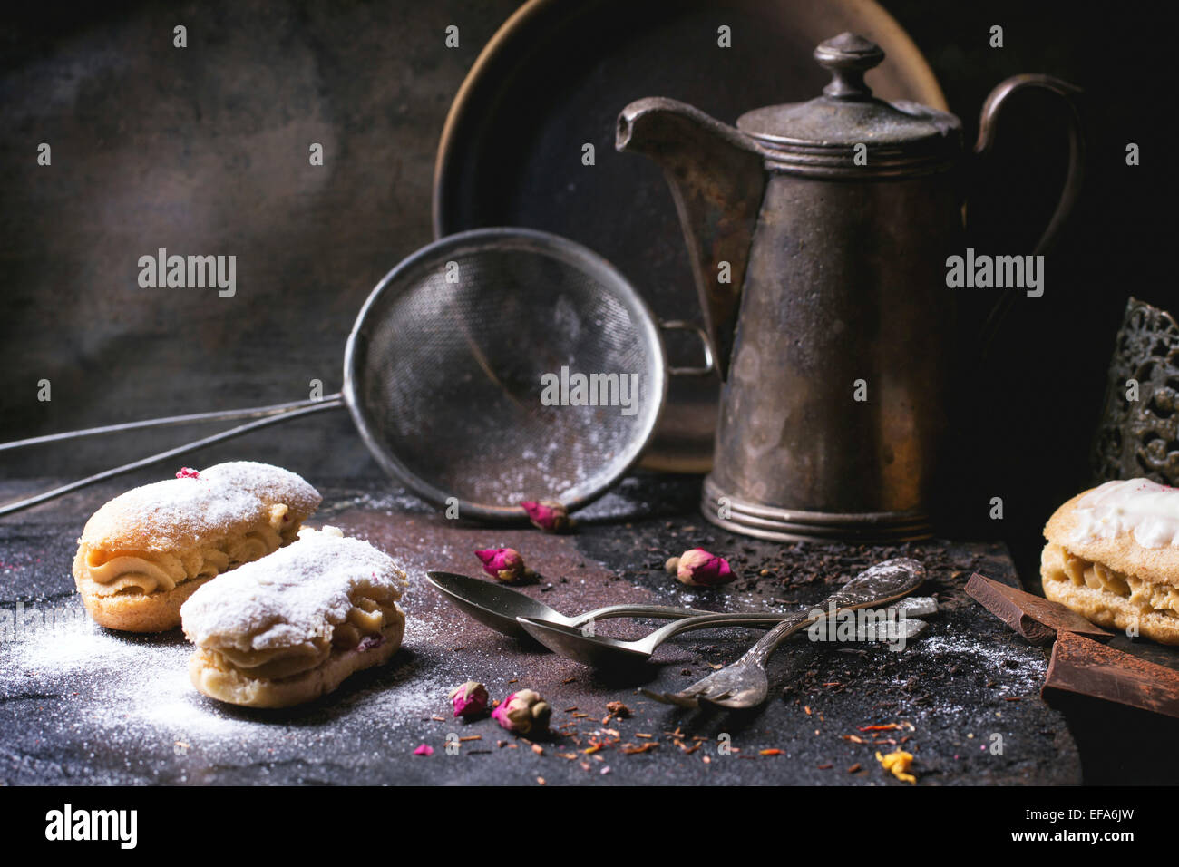 Tea drinking with eclairs and chopped chocolate, served with vintage ...