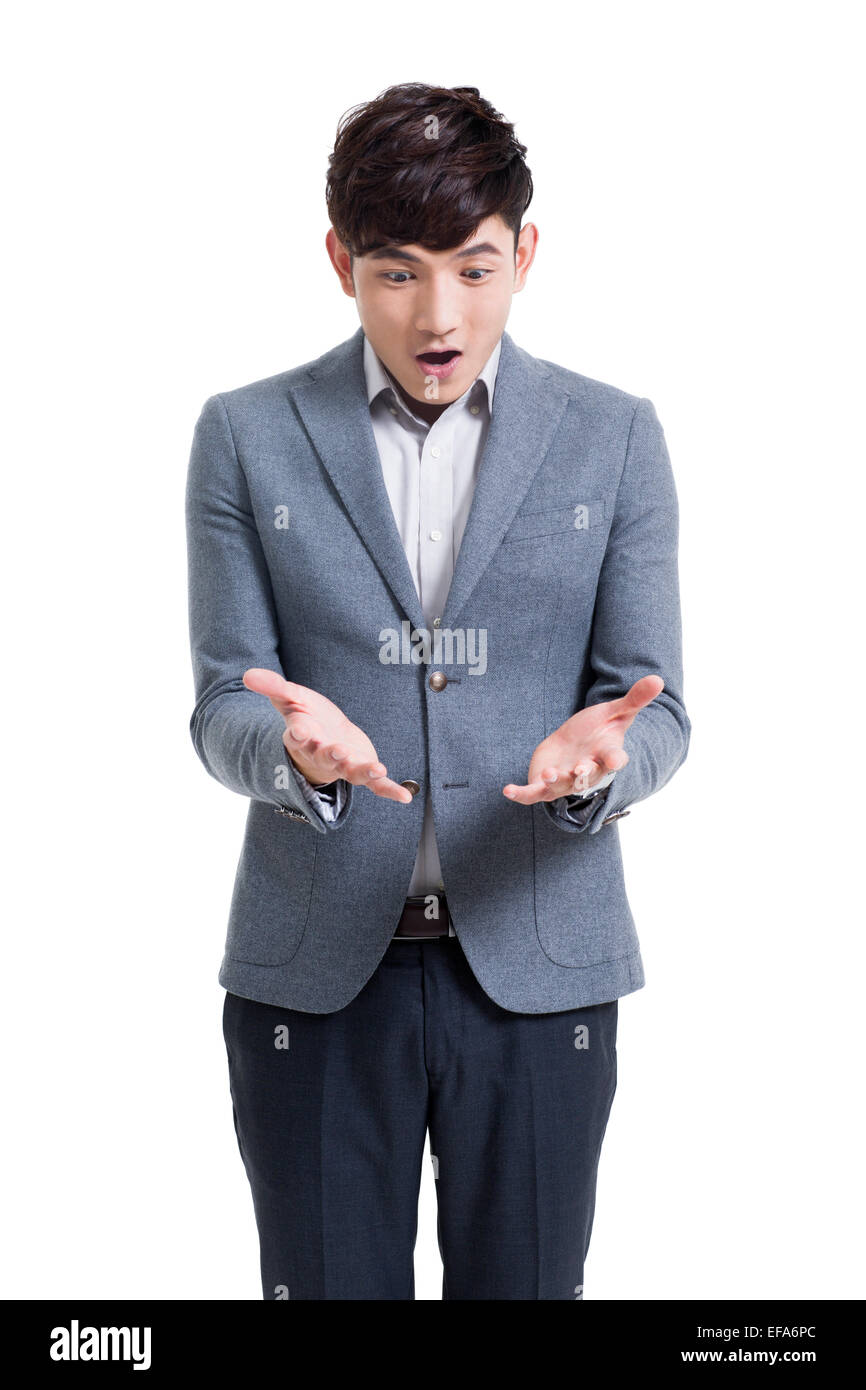 Surprised young man looking at his hands Stock Photo - Alamy